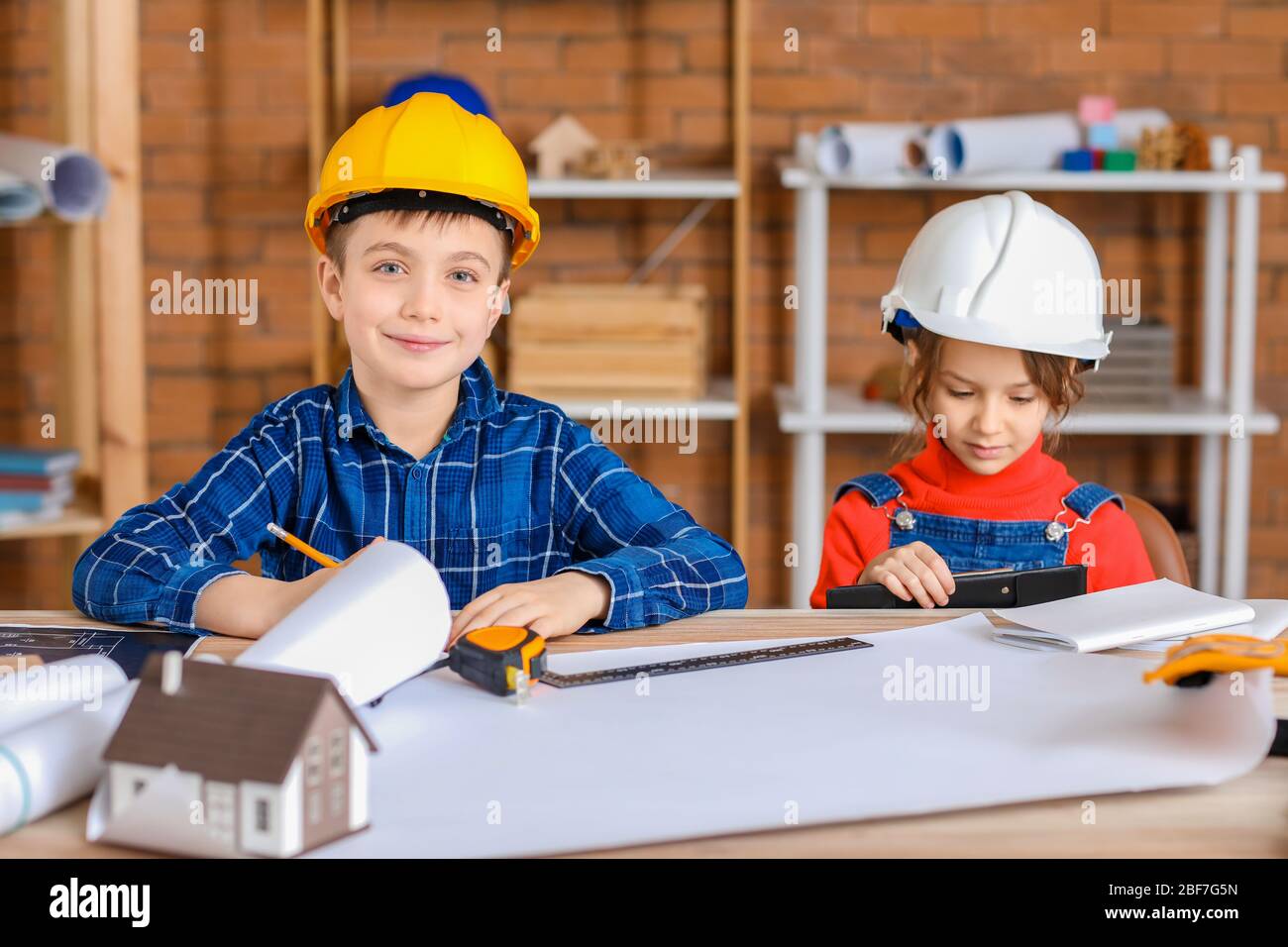 Cute little architects in office Stock Photo - Alamy