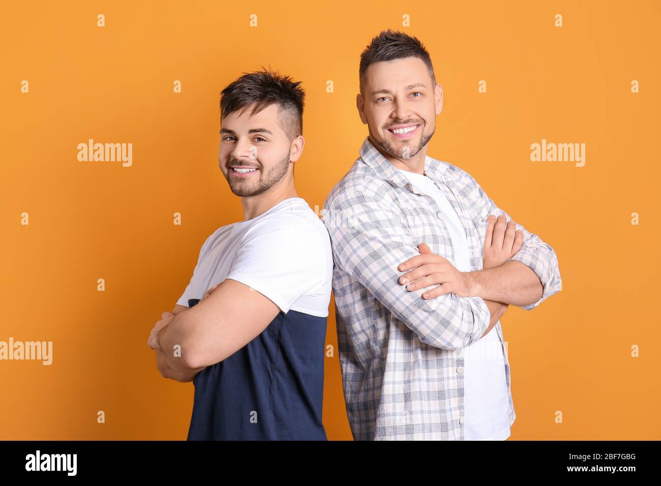 Portrait of happy friends on color background Stock Photo - Alamy