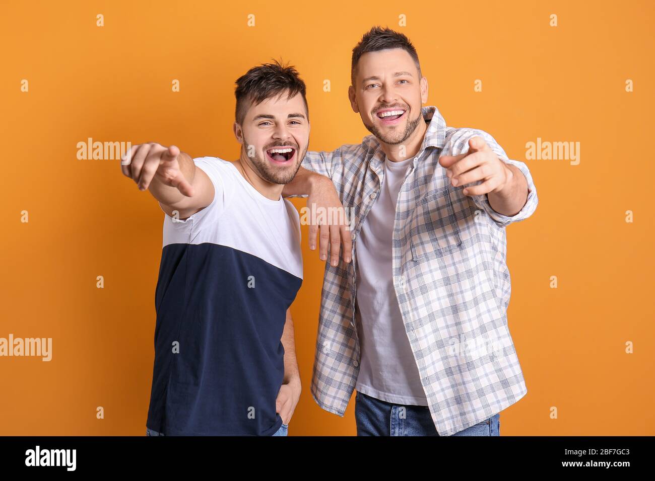 Positive young man pointing viewer hi-res stock photography and images ...