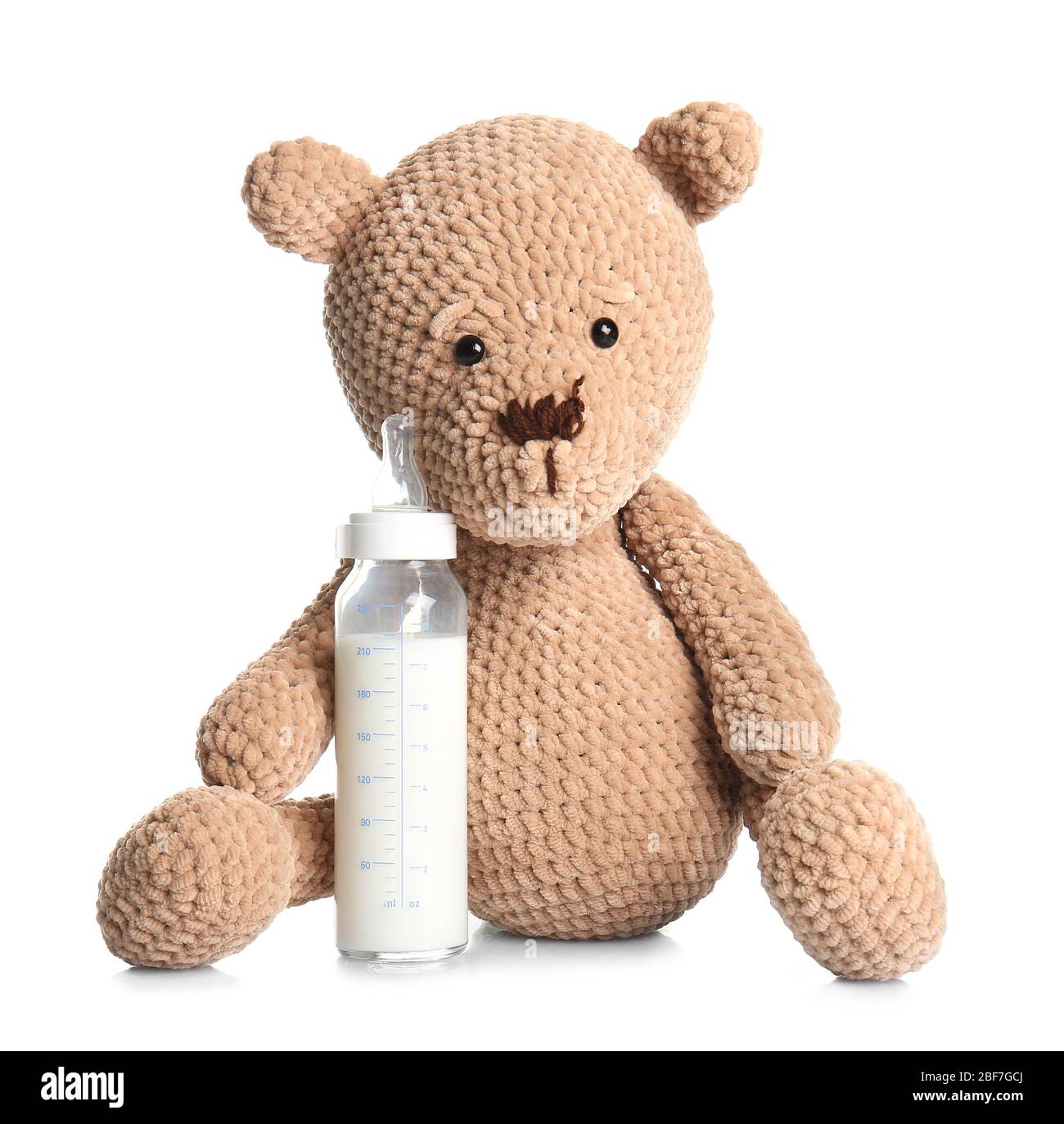 Teddy bear with bottle of milk for baby on white background Stock Photo ...
