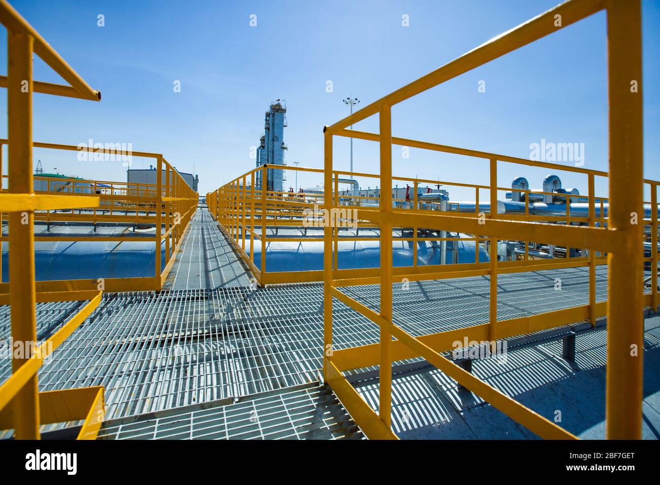 Oil refinery and gas processing plant. Yellow balustrade and ...