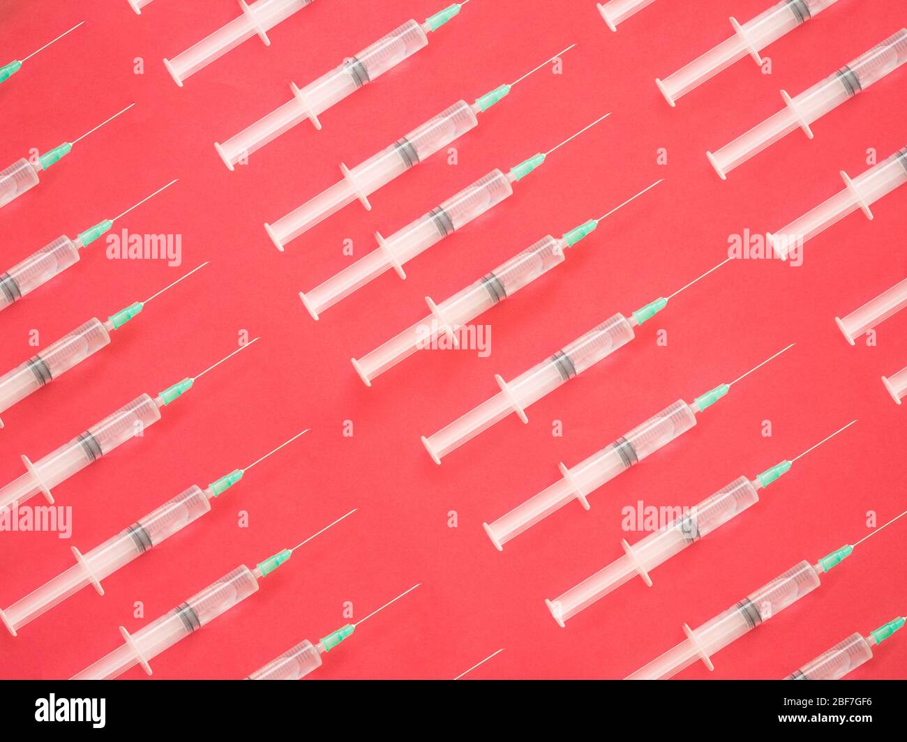 Syringe pattern on red background Stock Photo - Alamy