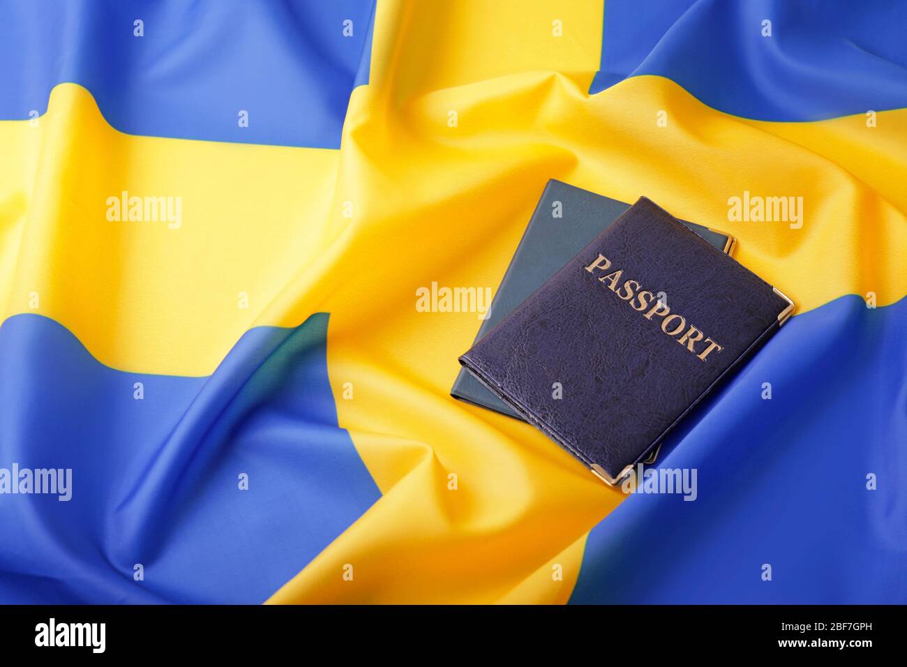 Passports on flag of Sweden. Immigration concept Stock Photo - Alamy