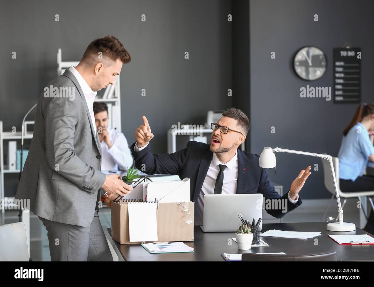 Angry boss firing office worker Stock Photo - Alamy