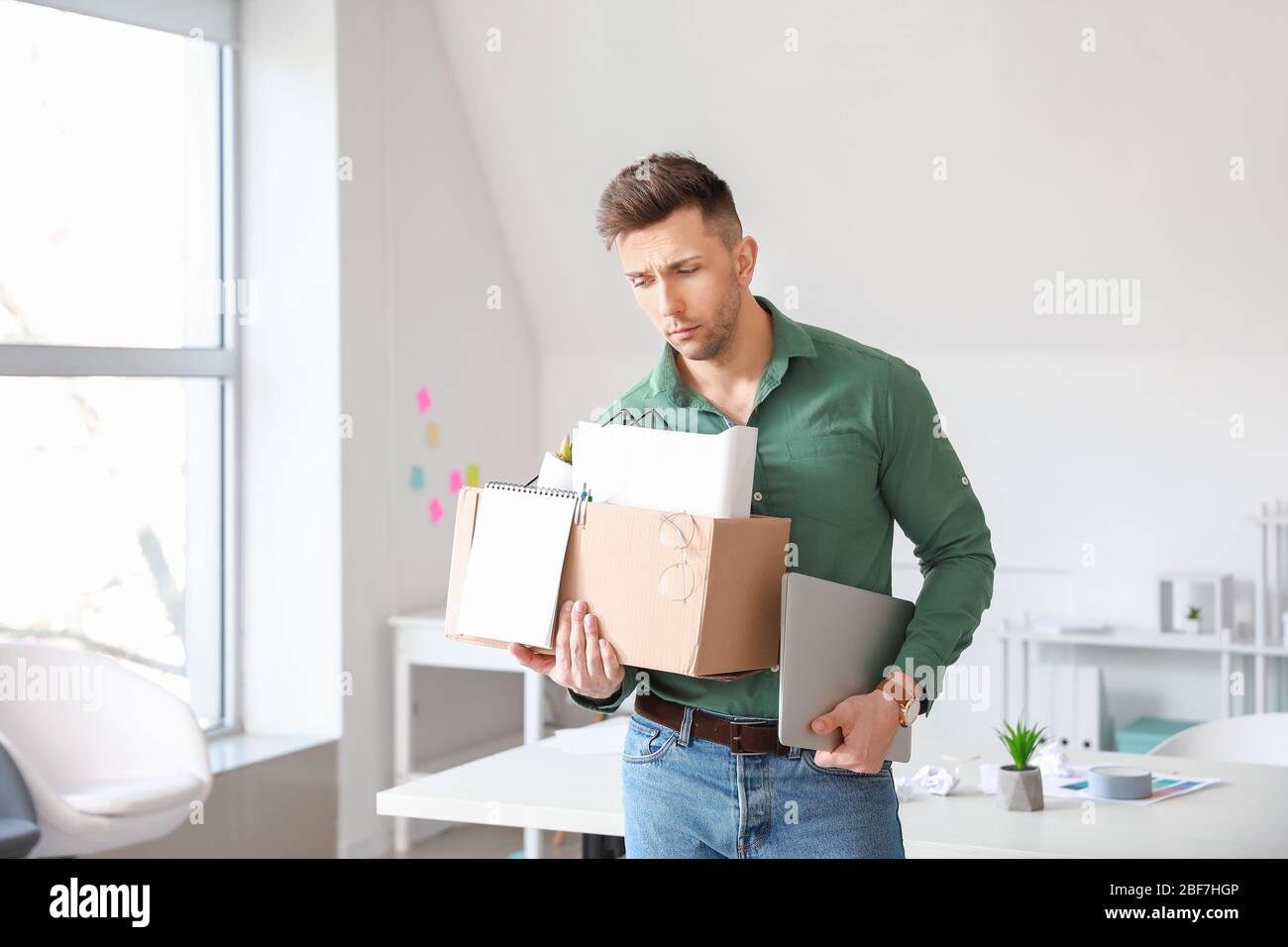 Sad fired man in office Stock Photo - Alamy