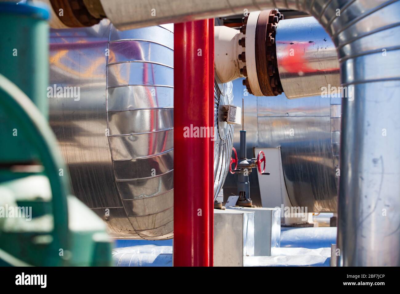 Petrochemical plant, oil refinery plant. Red valves, metal pipes and ...