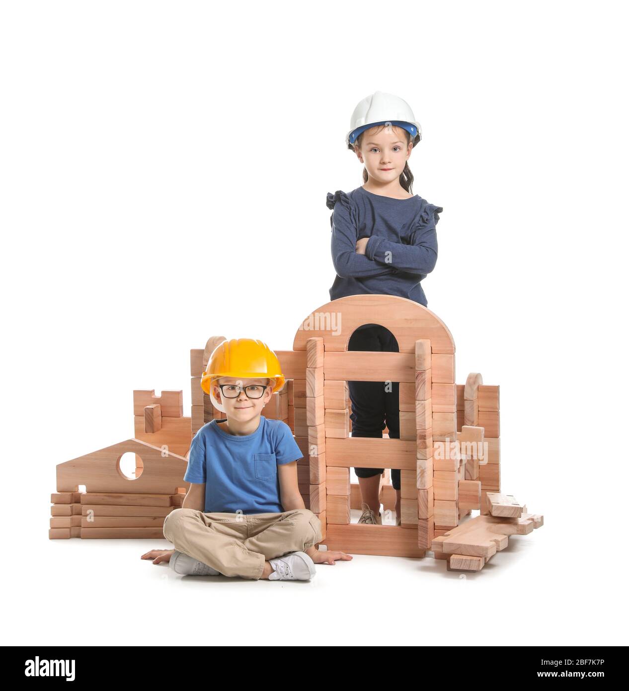 Little children dressed as builders playing with take-apart house on ...
