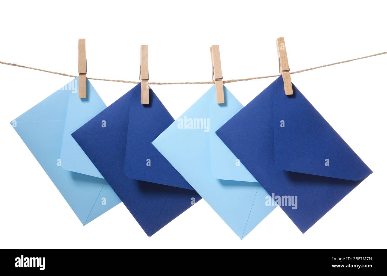 Paper envelopes hanging on rope against white background Stock Photo ...