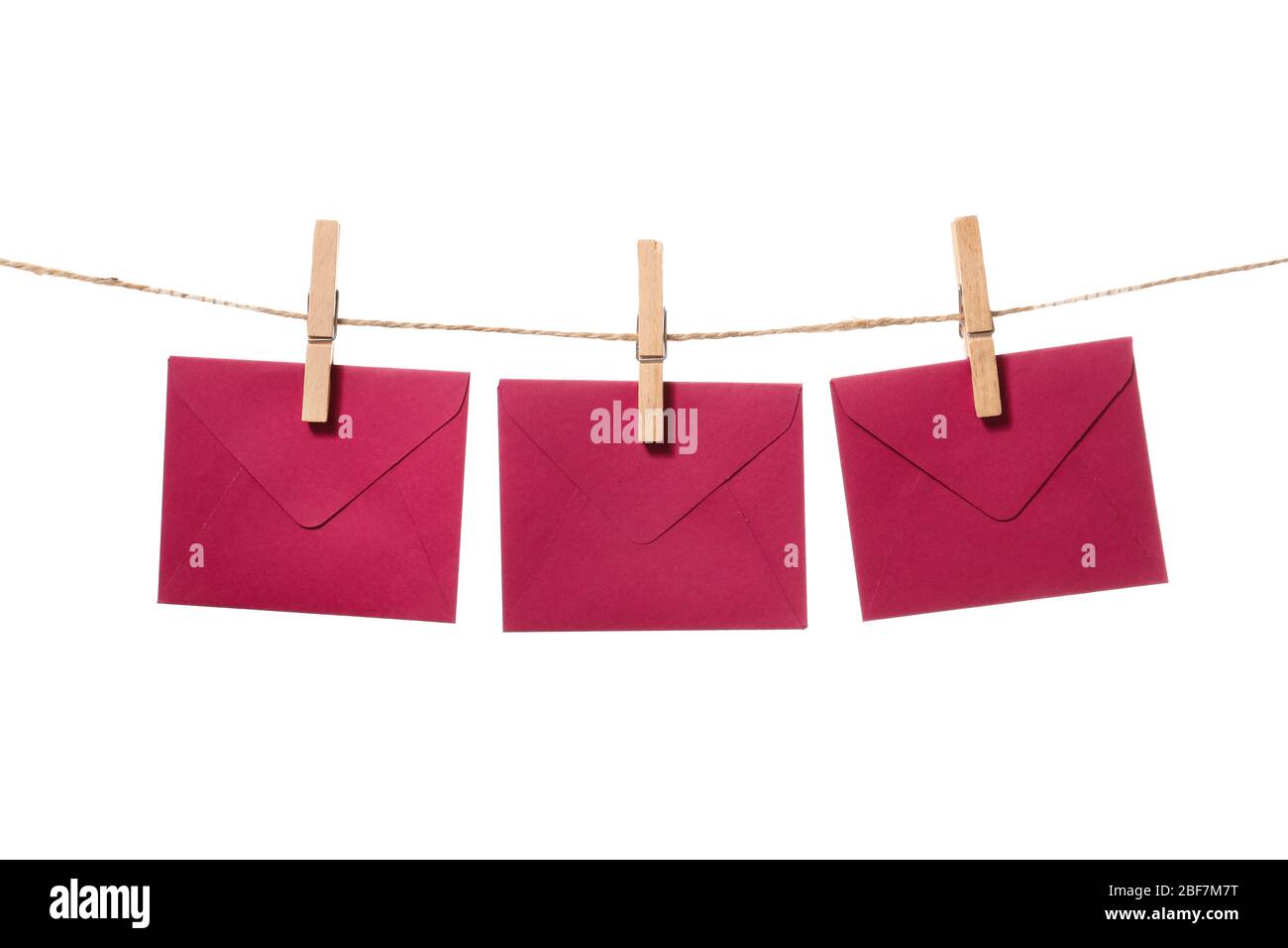 Paper envelopes hanging on rope against white background Stock Photo ...