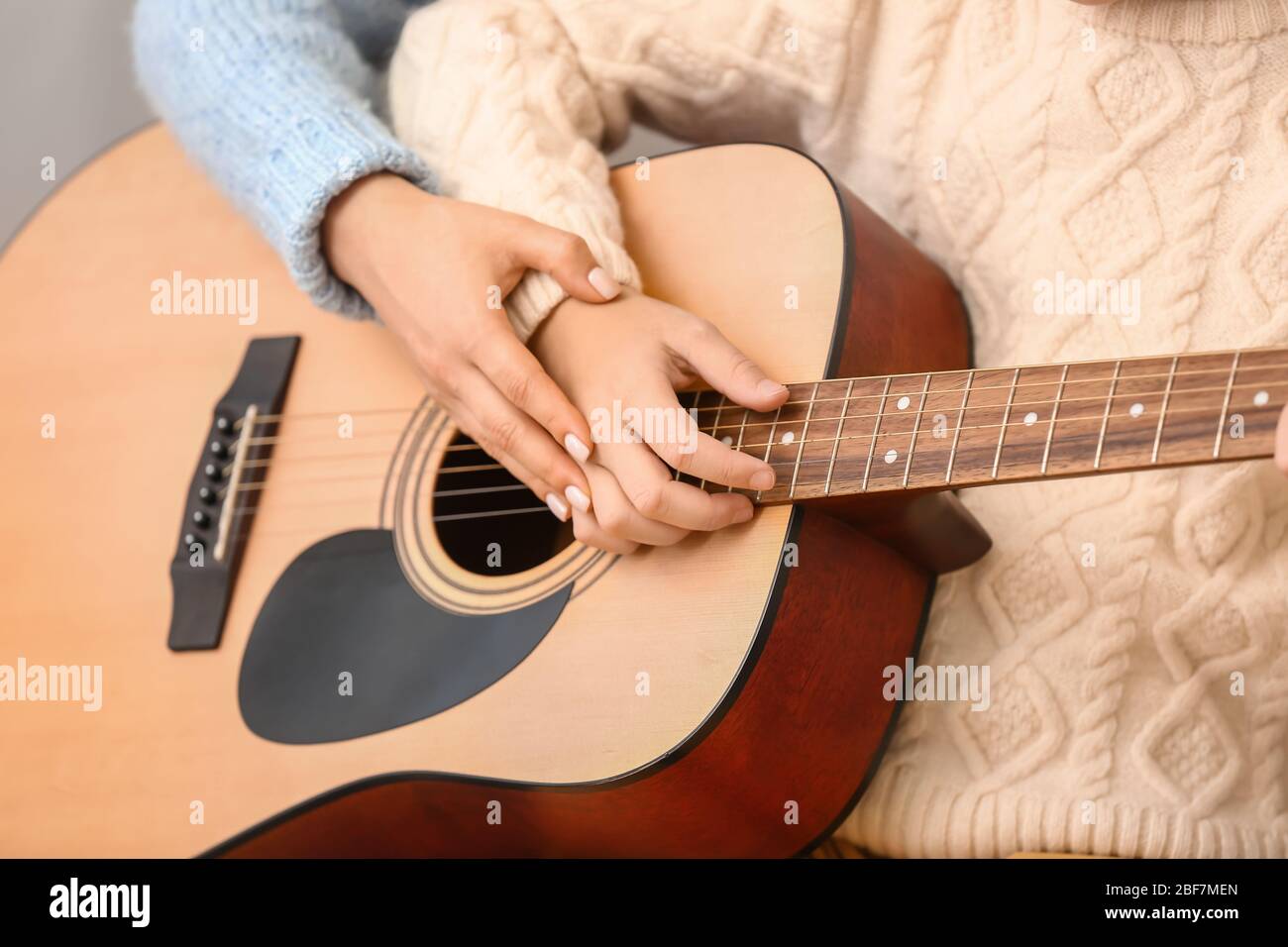 Private music teacher giving guitar lessons to little boy at home ...
