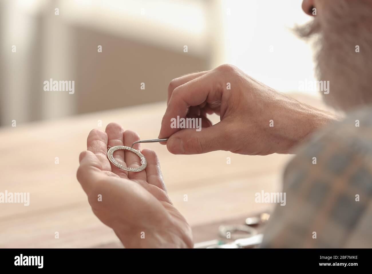 Jeweler making adornment in workshop, closeup Stock Photo - Alamy