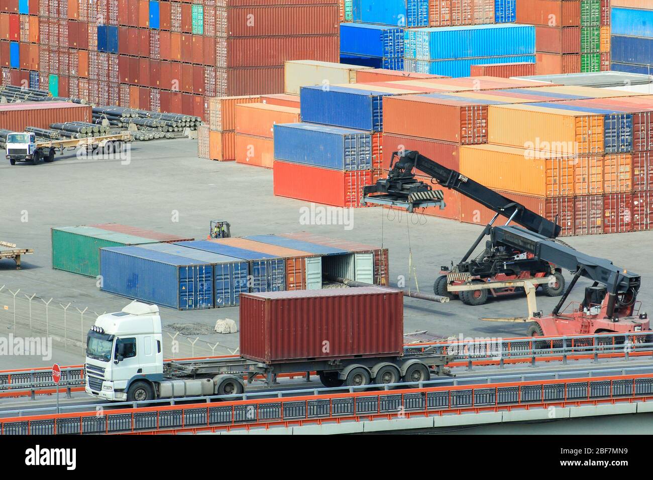Forklifts loads containers at container terminal. Logistics import ...