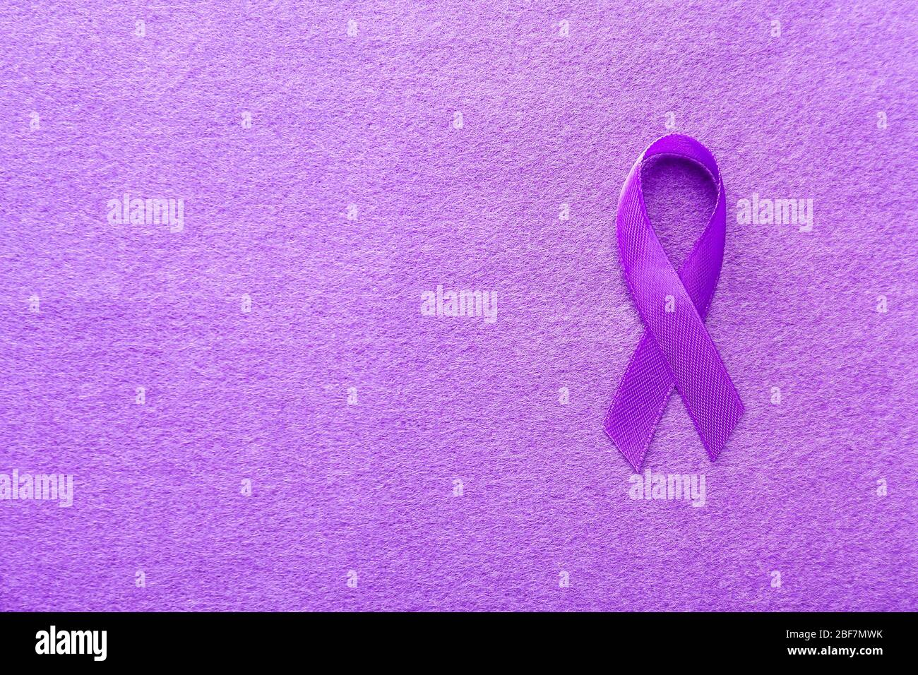 Violet ribbon on color background. Domestic violence concept Stock ...