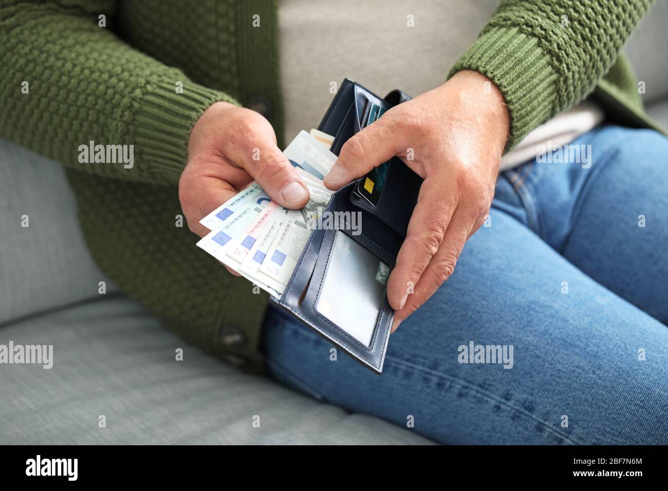 Senior man with purse at home, closeup Stock Photo - Alamy