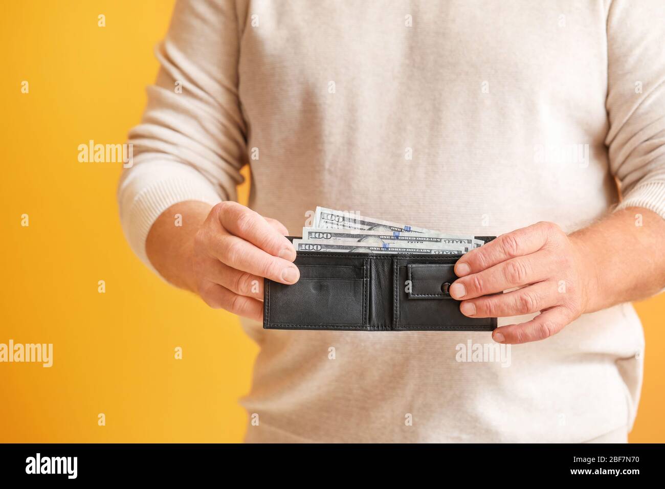 Senior man with purse on color background, closeup Stock Photo - Alamy