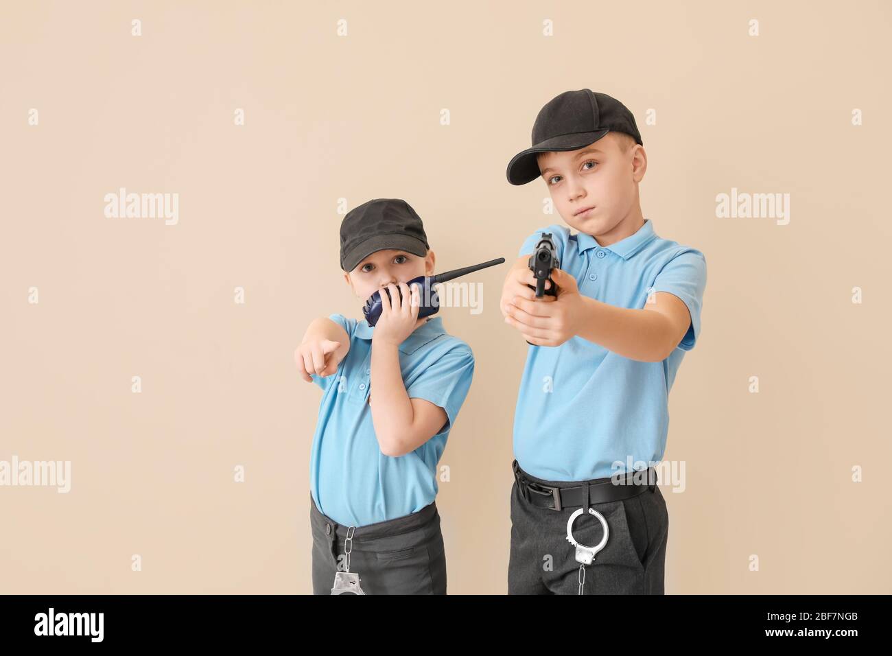Cute little police officers on color background Stock Photo - Alamy