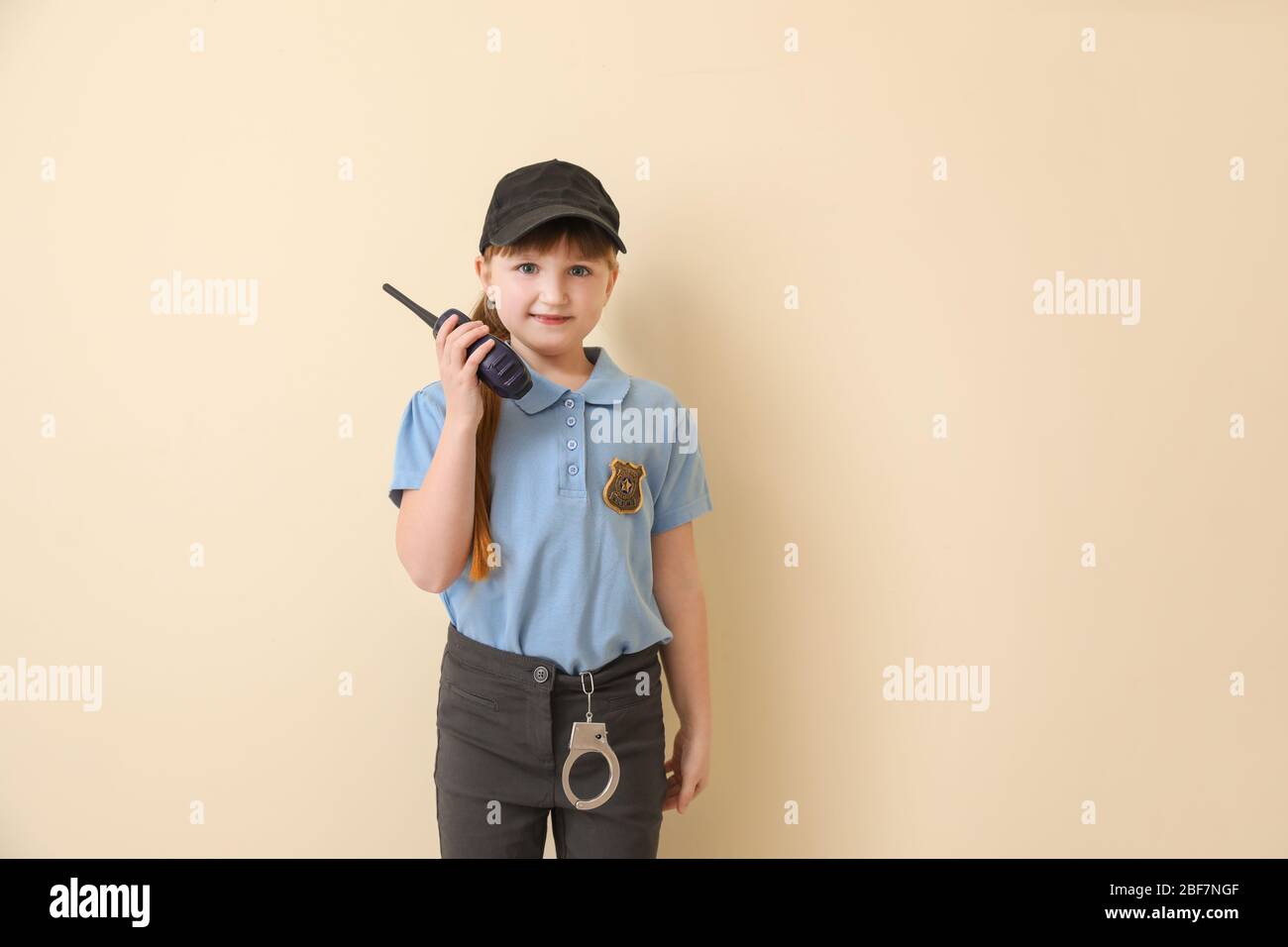 Cute little police officer on color background Stock Photo - Alamy