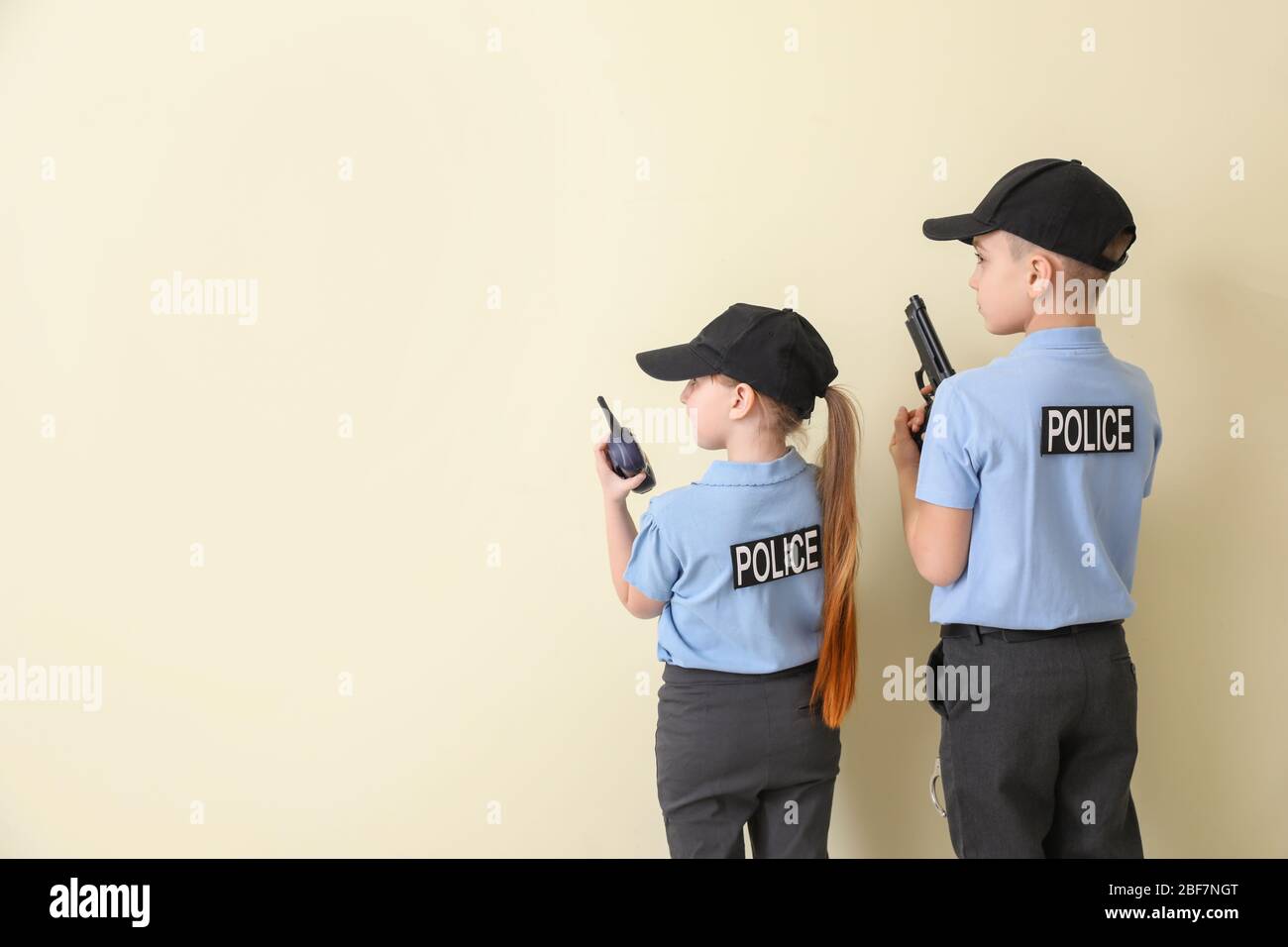Cute little police officers on color background Stock Photo - Alamy