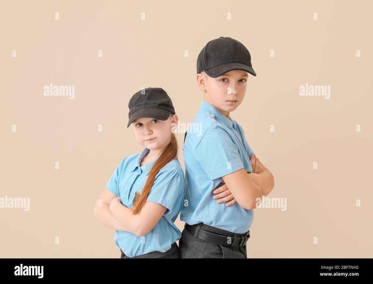 Cute little police officers on color background Stock Photo - Alamy