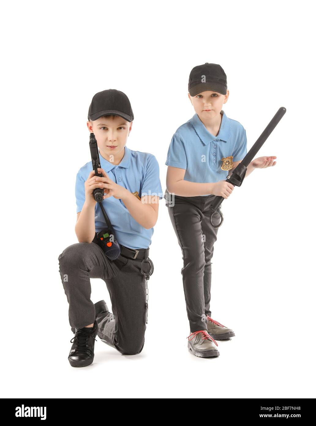 Cute little police officers on white background Stock Photo - Alamy