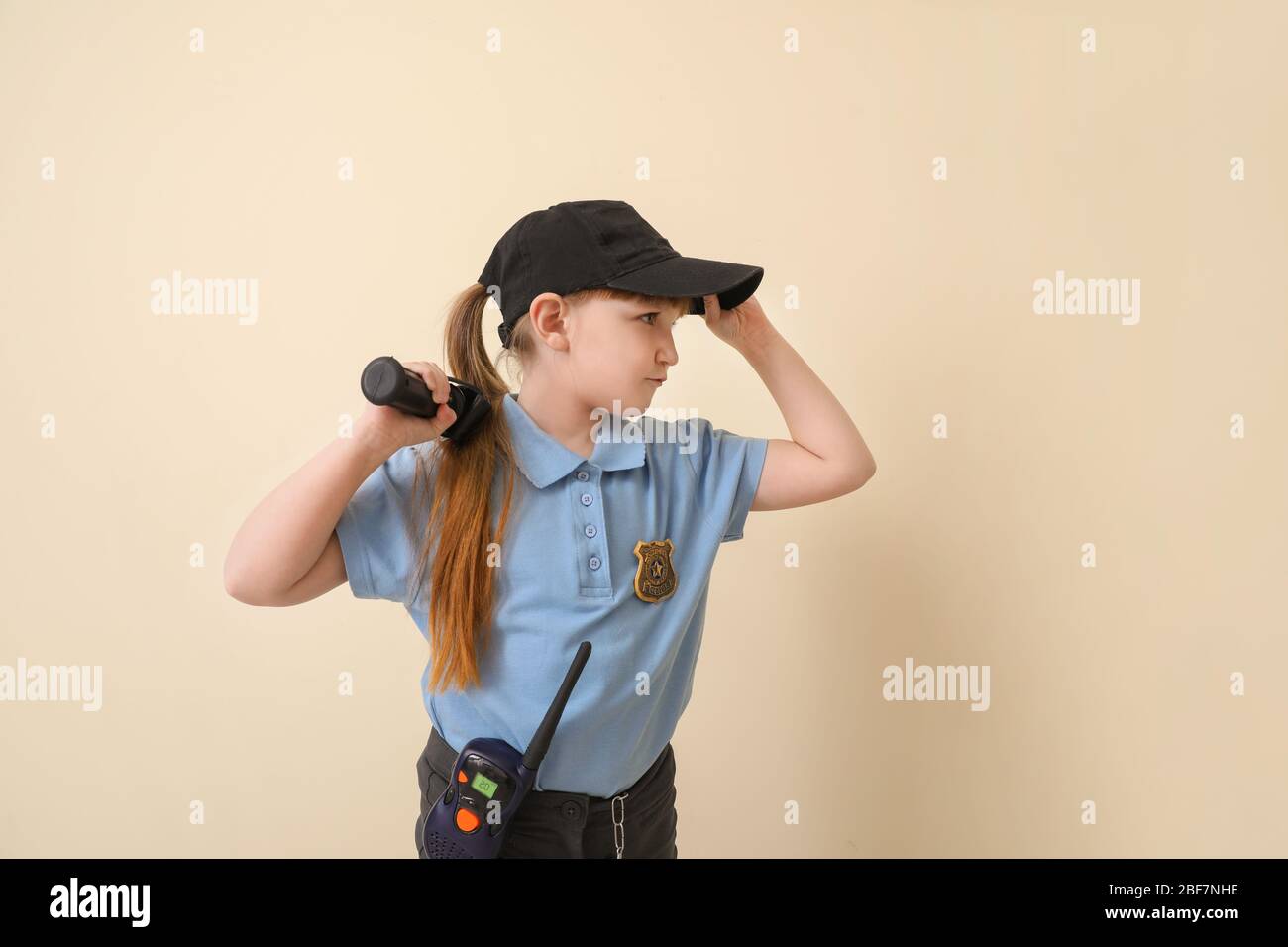 Cute little police officer on color background Stock Photo - Alamy