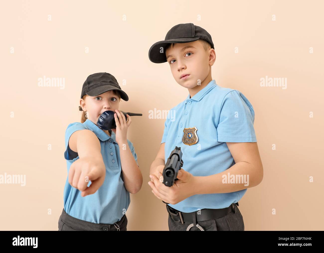 Cute little police officers on color background Stock Photo - Alamy
