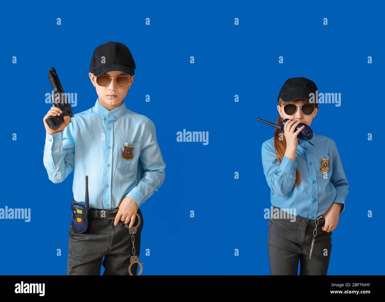 Cute little police officers on color background Stock Photo - Alamy
