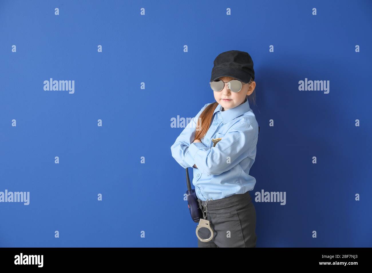 Cute little police officer on color background Stock Photo - Alamy