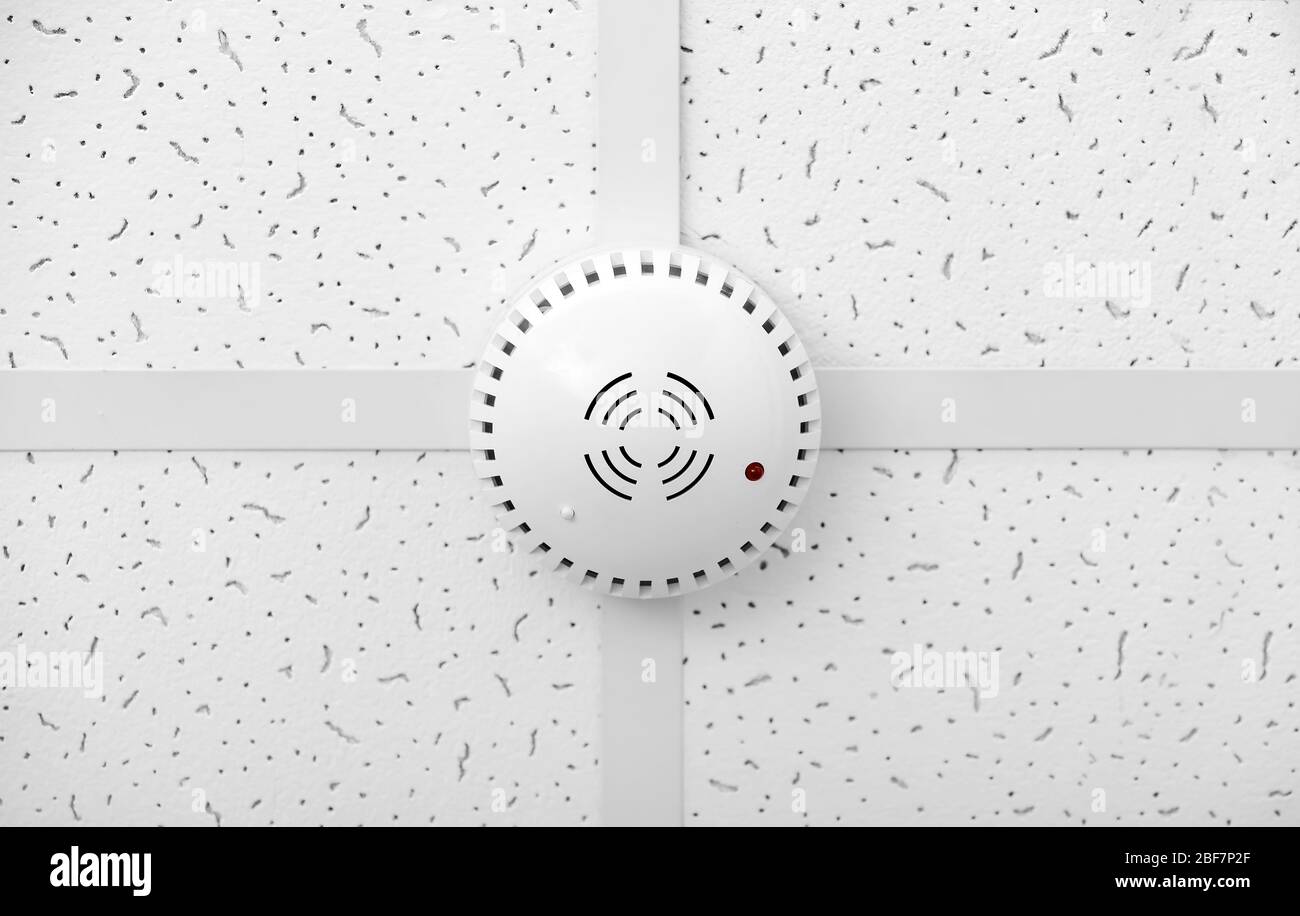 Modern smoke detector on ceiling, bottom view Stock Photo - Alamy