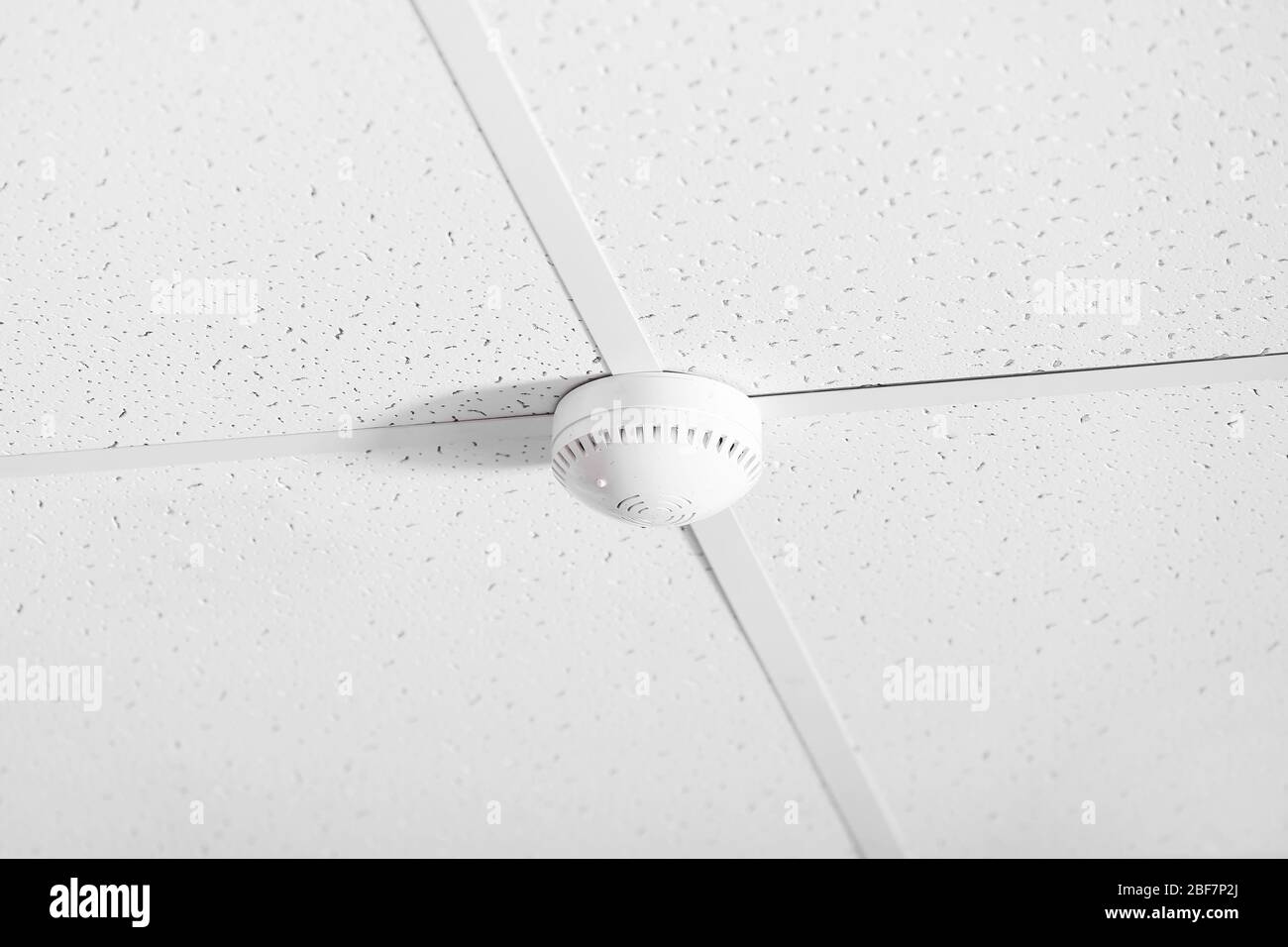 Modern smoke detector on ceiling Stock Photo - Alamy