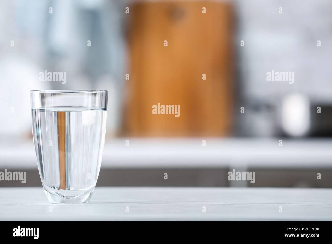Glass of fresh cold water on table in kitchen Stock Photo - Alamy