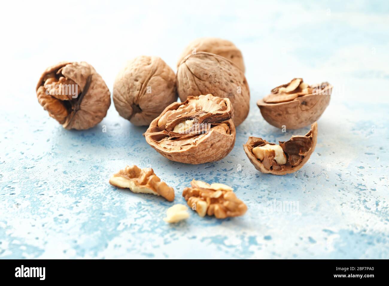 Tasty walnuts on color background Stock Photo - Alamy