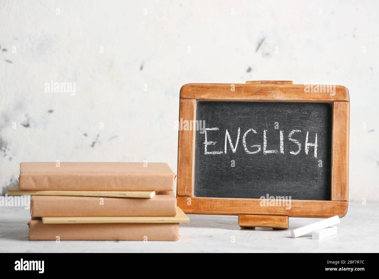 Chalkboard with text ENGLISH and books on table Stock Photo - Alamy