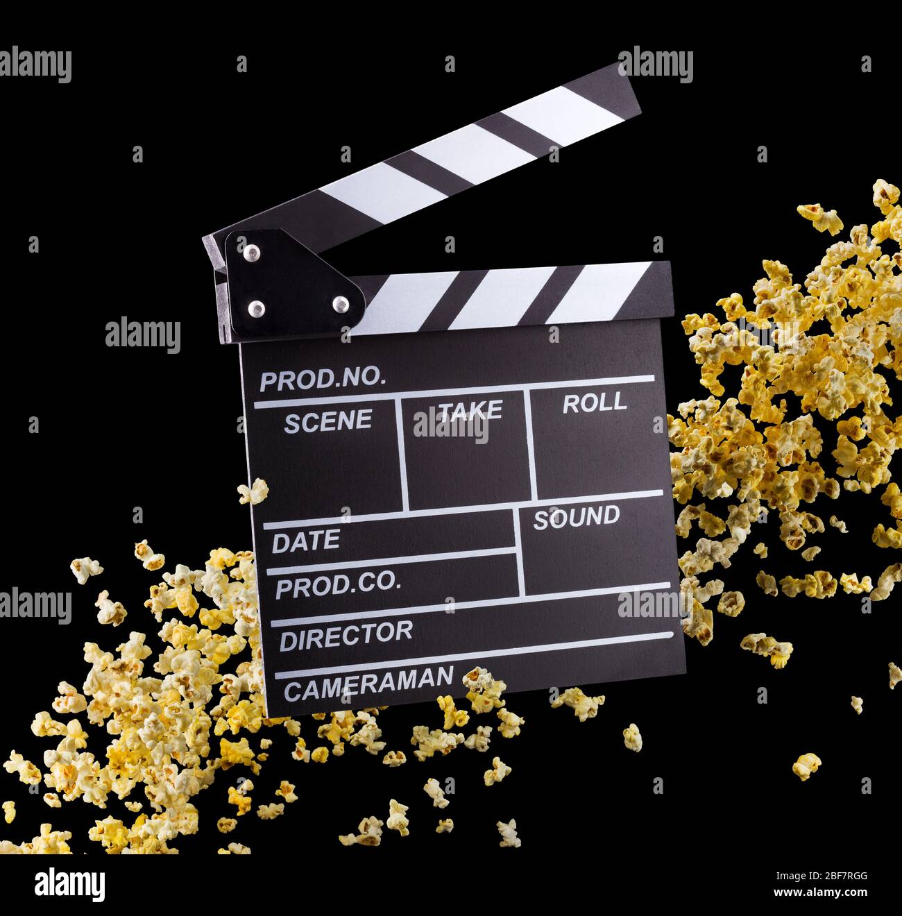 Flying popcorn and film clapper board isolated on black background ...