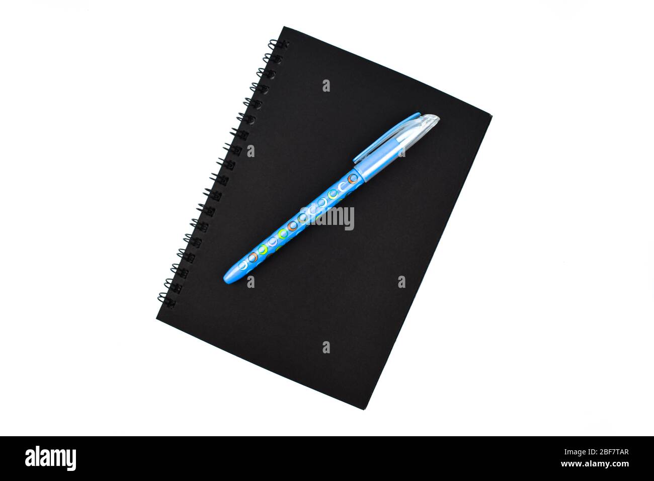 Light blue colored pen placed on top of a simple medium size closed ...