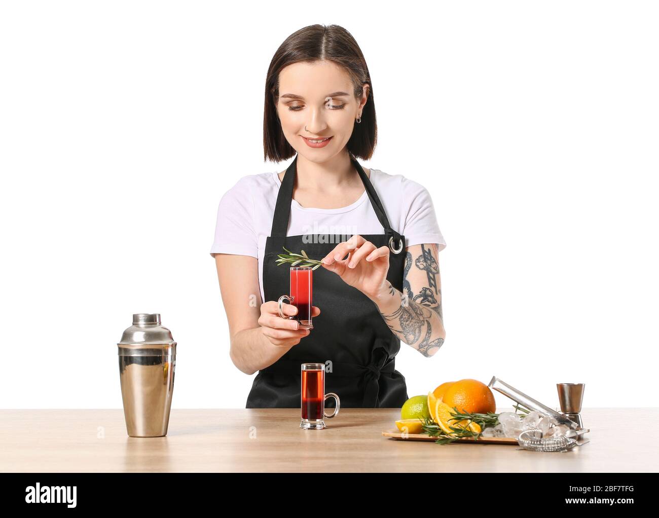 Beautiful female bartender at table against white background Stock ...