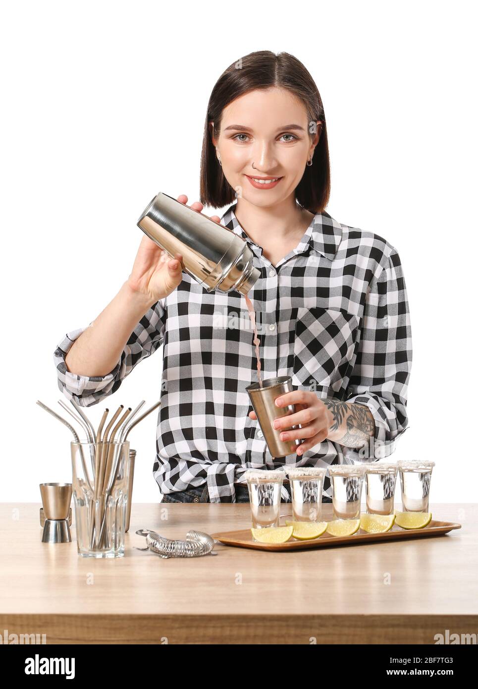 Beautiful female bartender at table against white background Stock ...