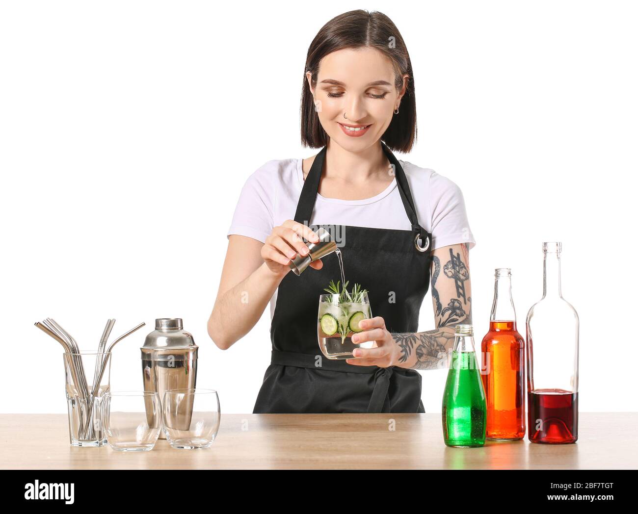 Beautiful female bartender at table against white background Stock ...