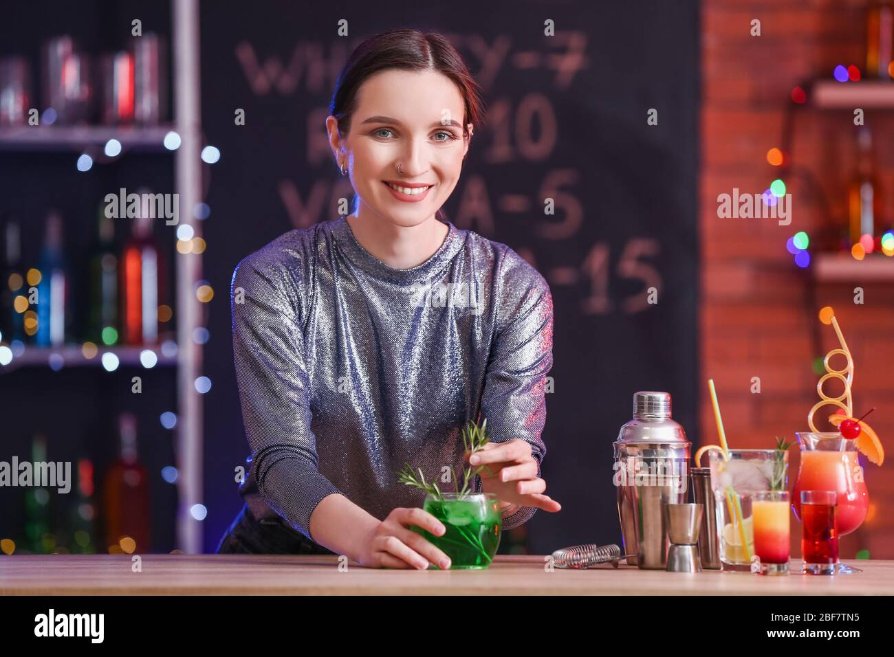 Beautiful female bartender in pub Stock Photo - Alamy