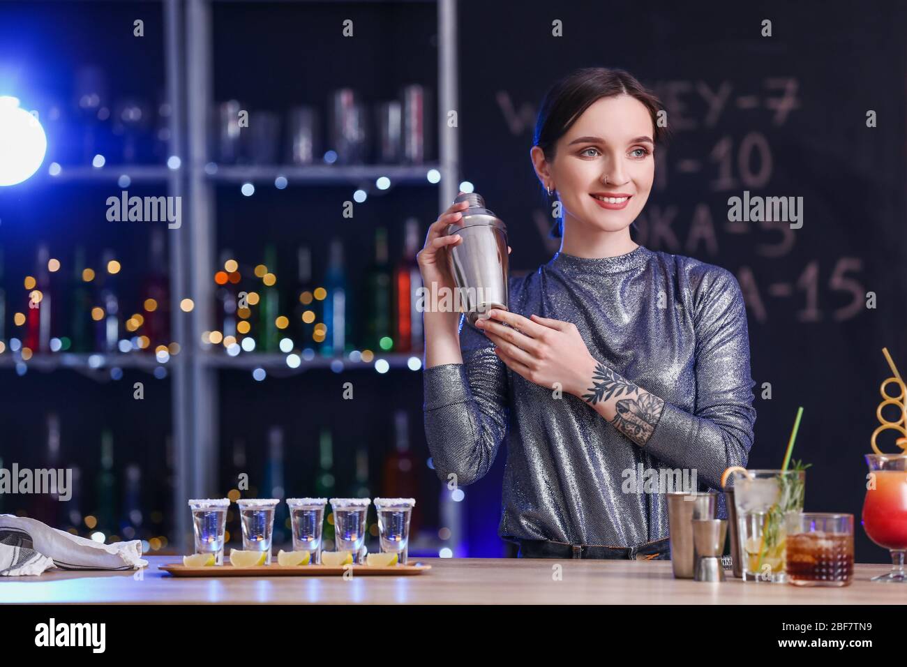 Beautiful female bartender in pub Stock Photo - Alamy