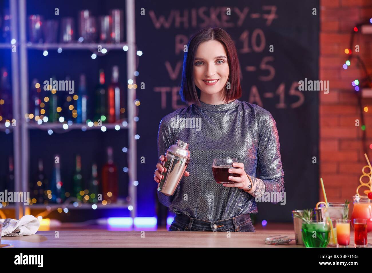 Beautiful female bartender in pub Stock Photo - Alamy