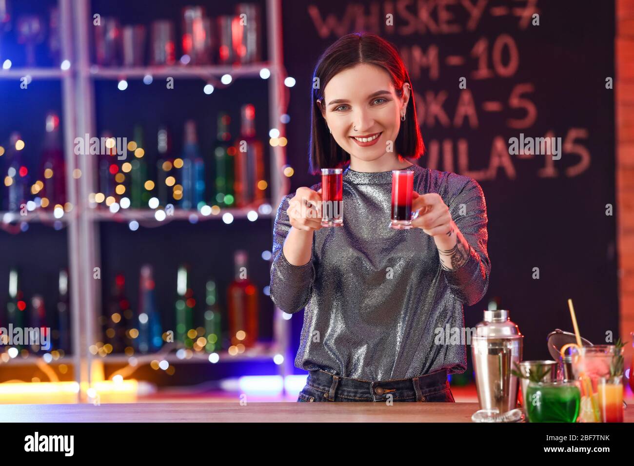 Beautiful female bartender in pub Stock Photo - Alamy