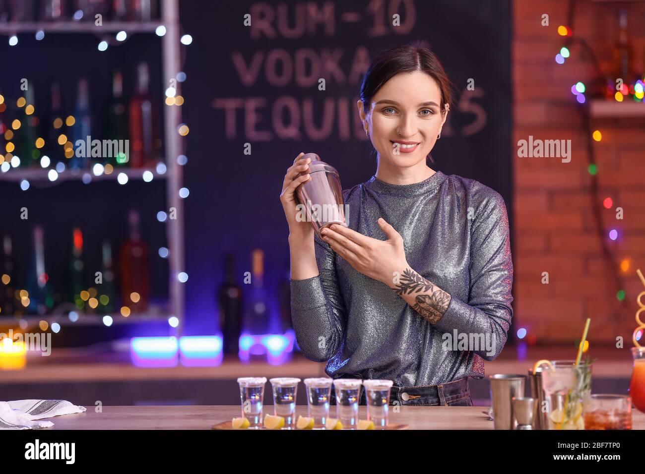 Beautiful female bartender in pub Stock Photo - Alamy