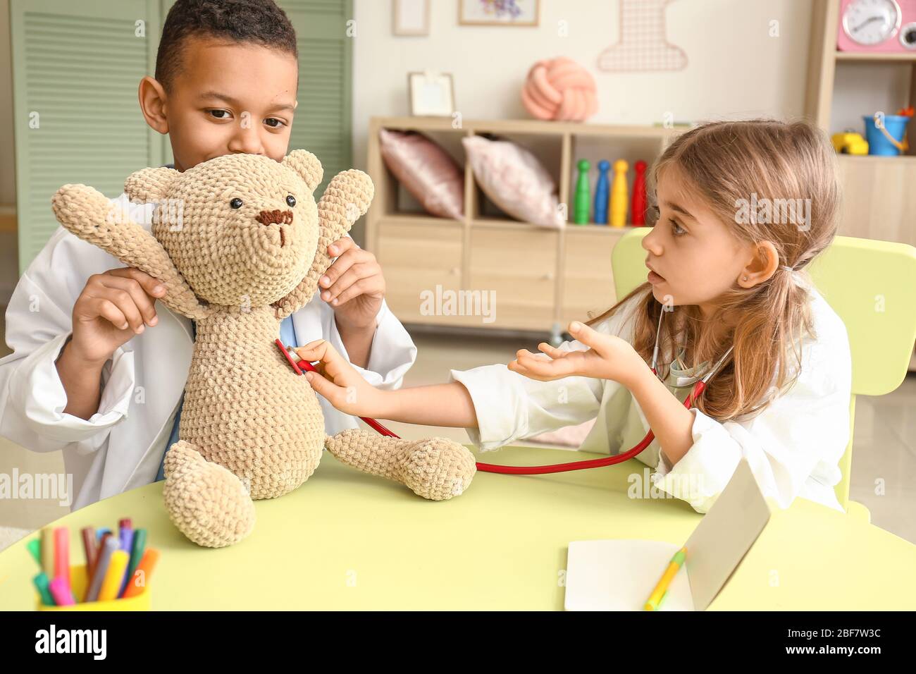Cute little children dressed as doctors playing at home Stock Photo - Alamy