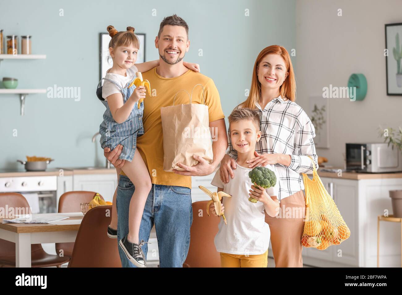 Family with fresh products from market in kitchen Stock Photo - Alamy