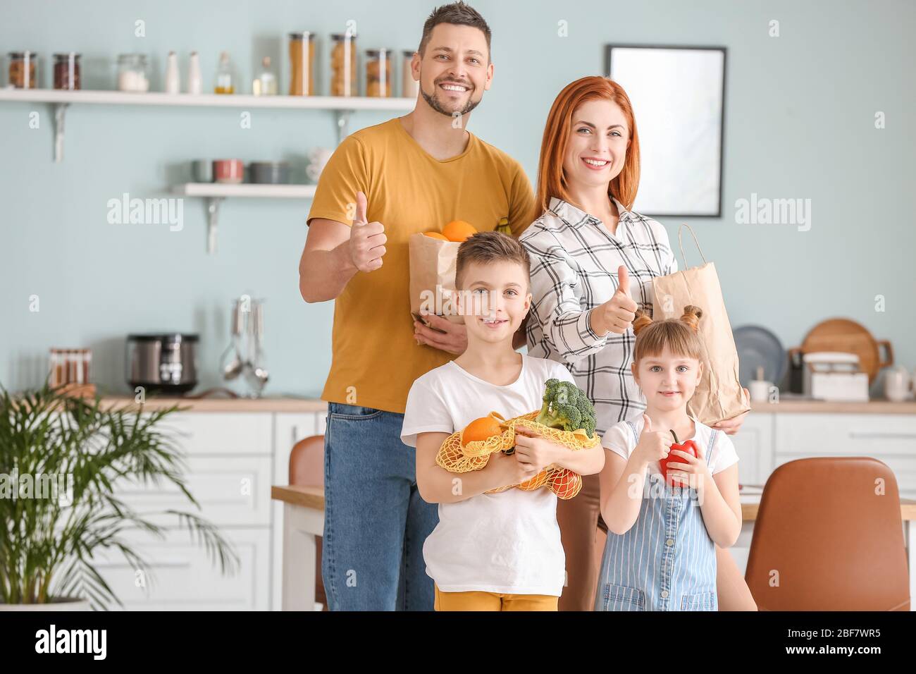 Family with fresh products from market in kitchen Stock Photo - Alamy