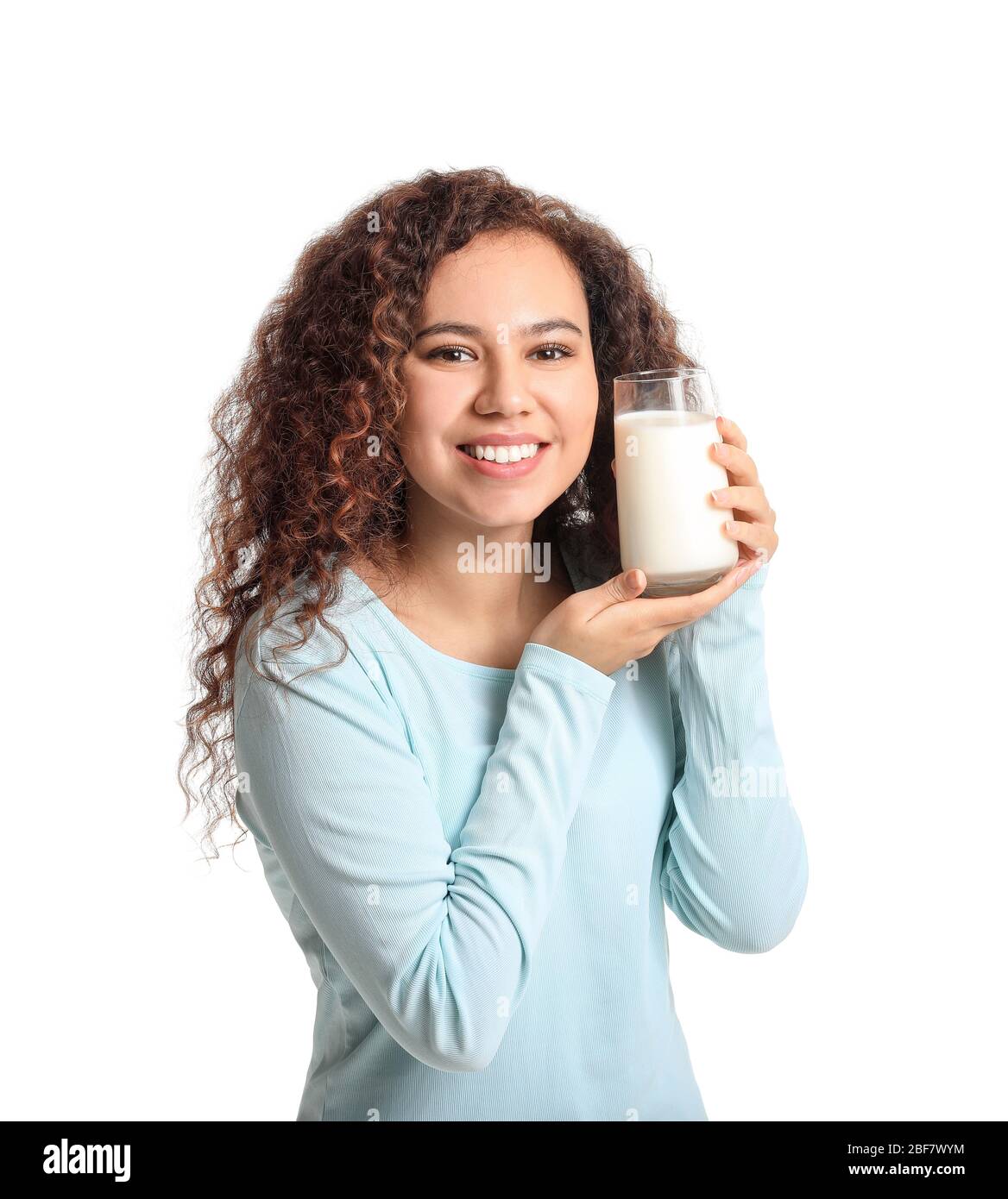 Young African-American woman with milk on white background Stock Photo ...