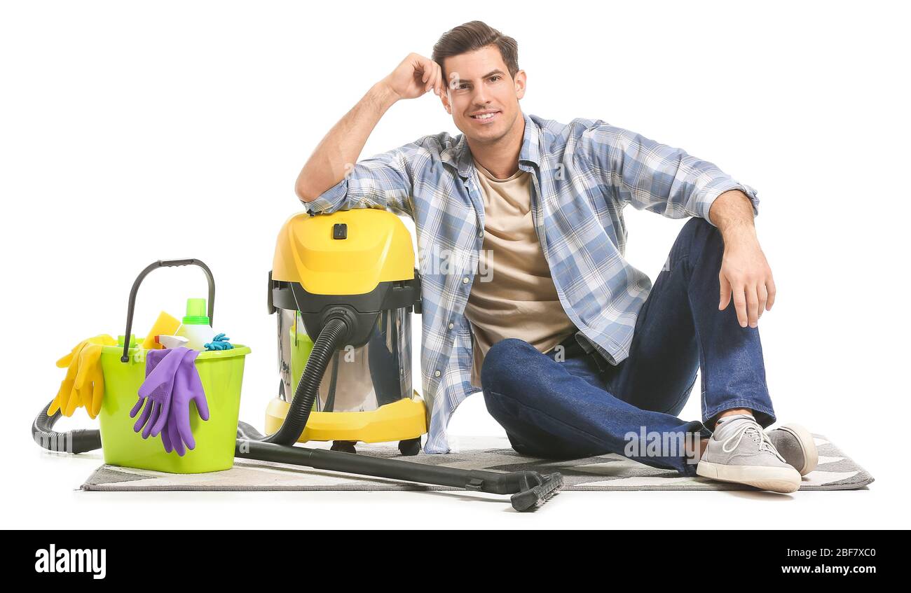 Man cleaning carpet vacuum cleaner Cut Out Stock Images & Pictures - Alamy