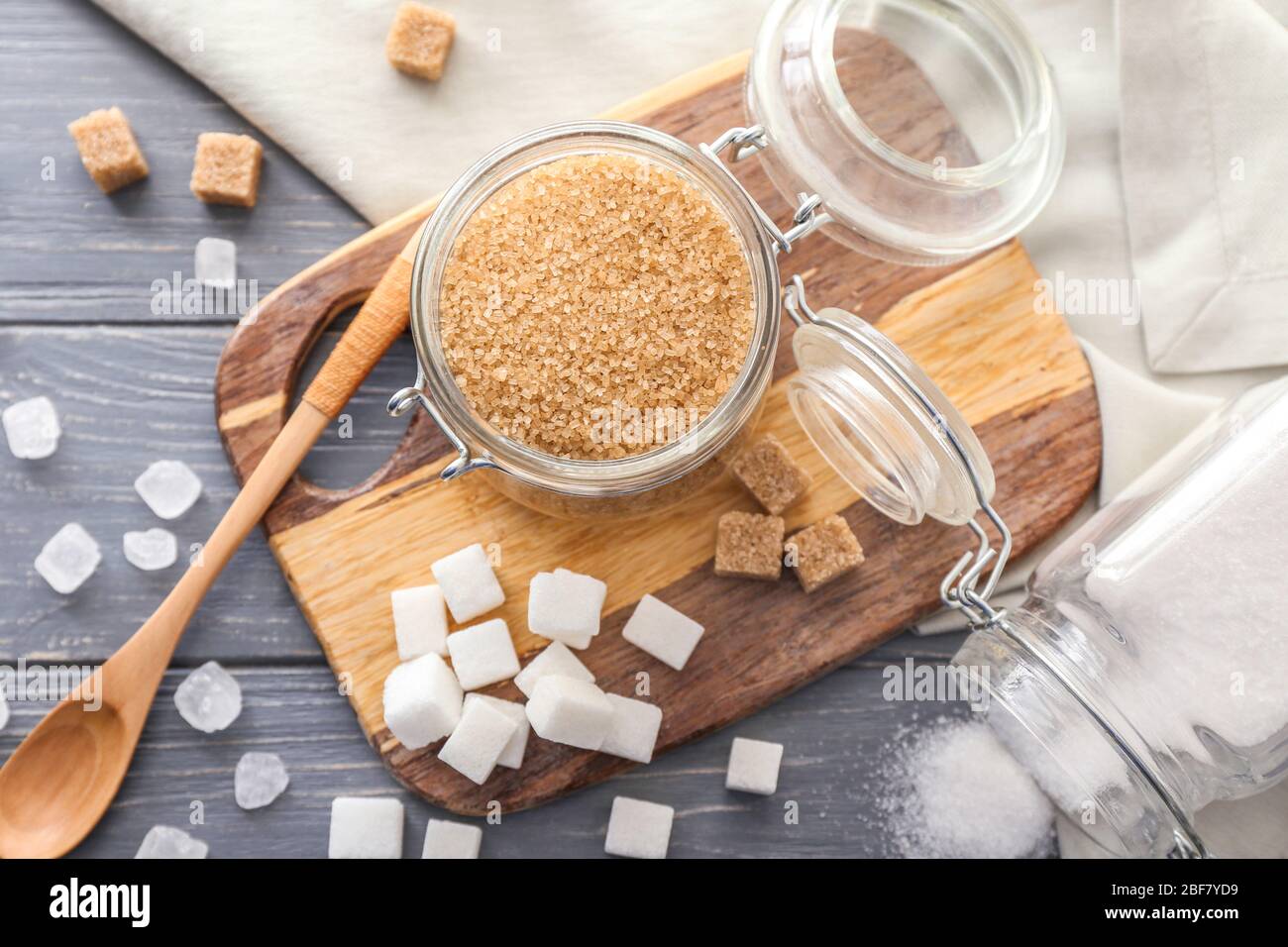 Different sugar on wooden background Stock Photo - Alamy