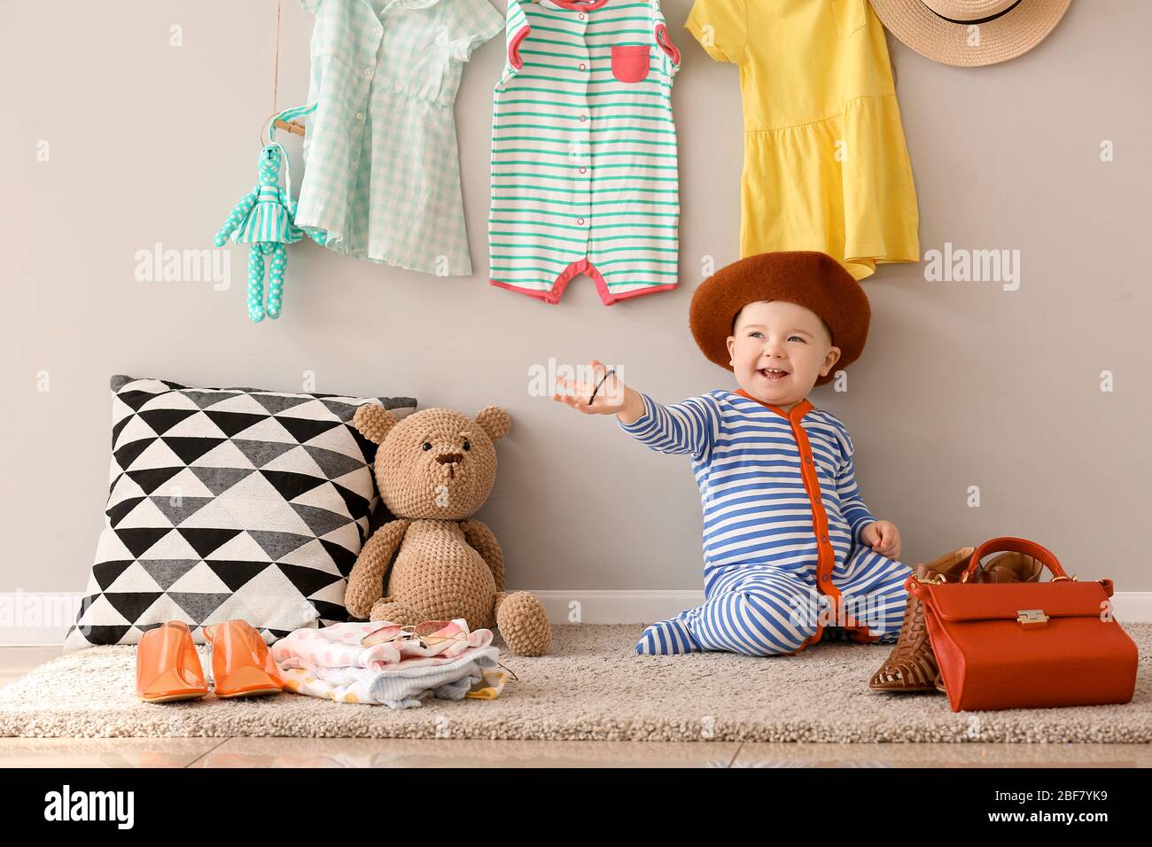 Cute baby with stylish clothes and accessories at home Stock Photo - Alamy